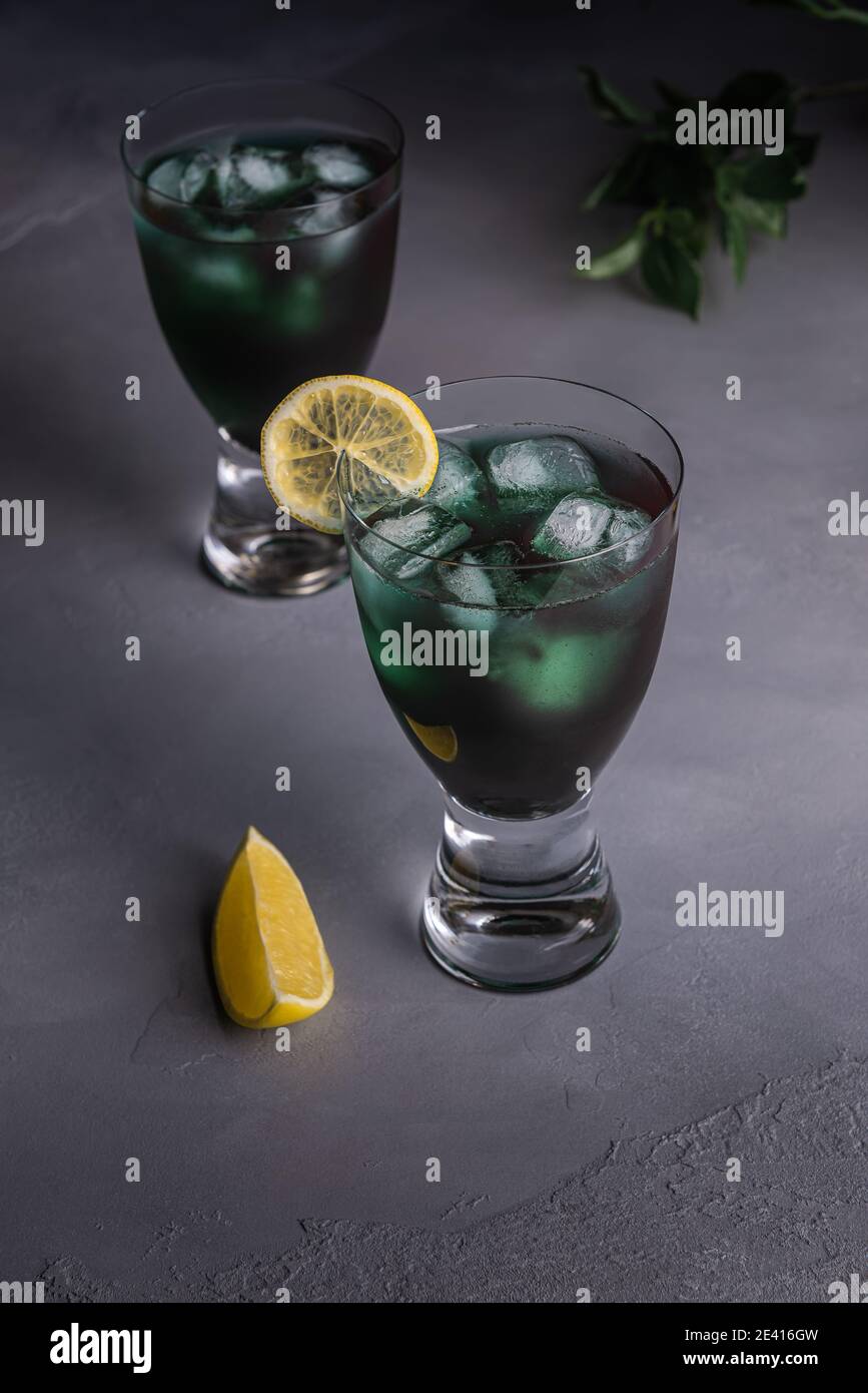 Green mocktail in glasses with chlorella or spirulina algae, lemon ...