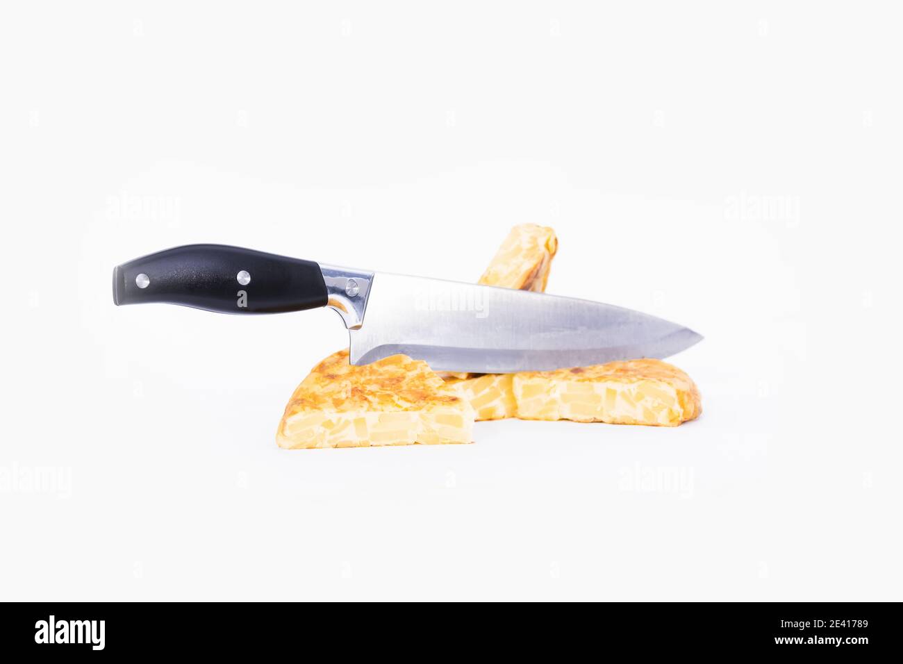 Knife cutting an omelet isolated on white background Stock Photo - Alamy