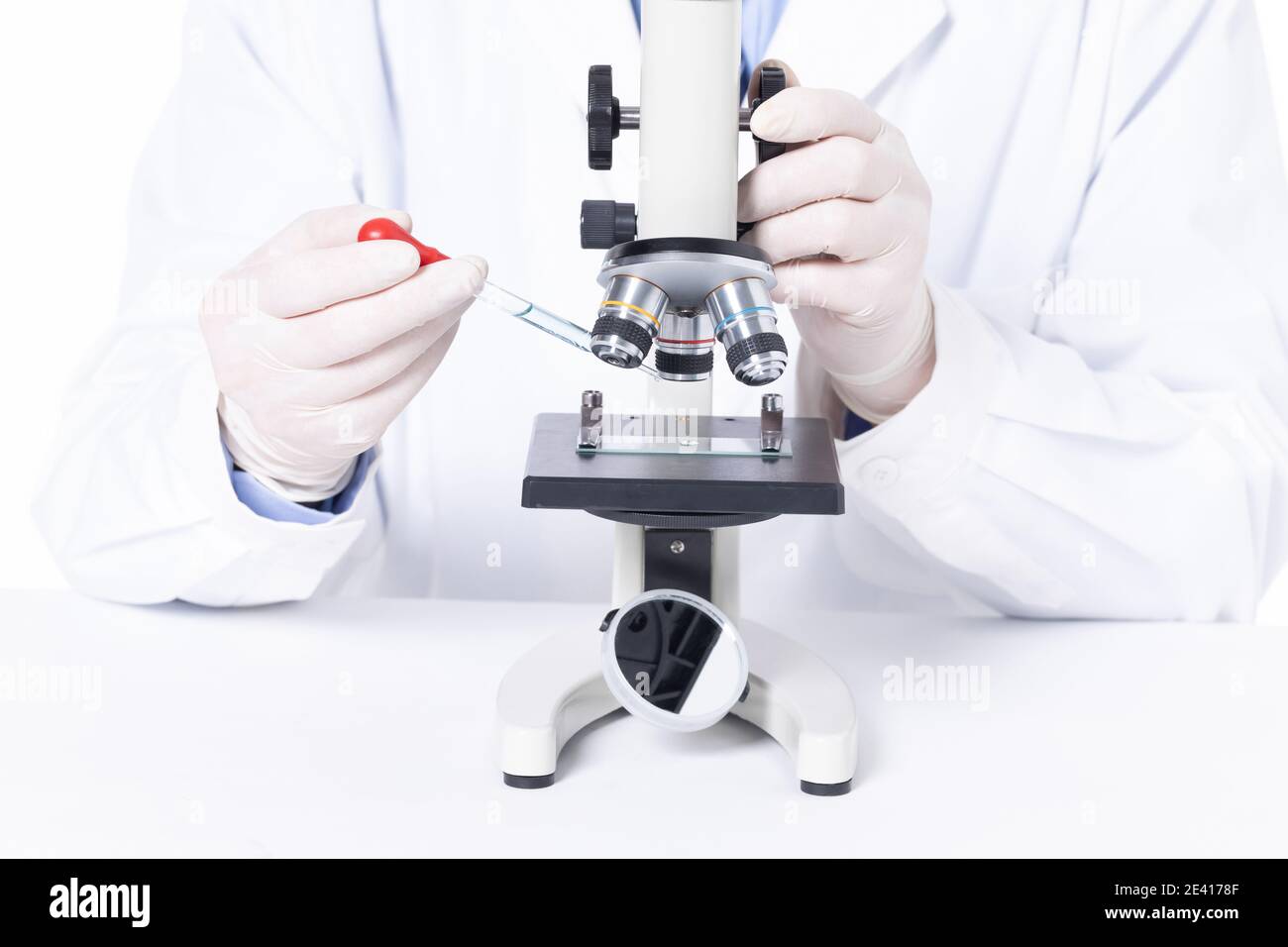 Closeup of a scientist examining toxic substances under a microscope in ...