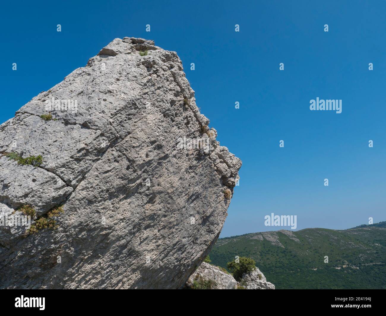 Big limestone boulder at heel of Perda Liana, rock formation on green ...