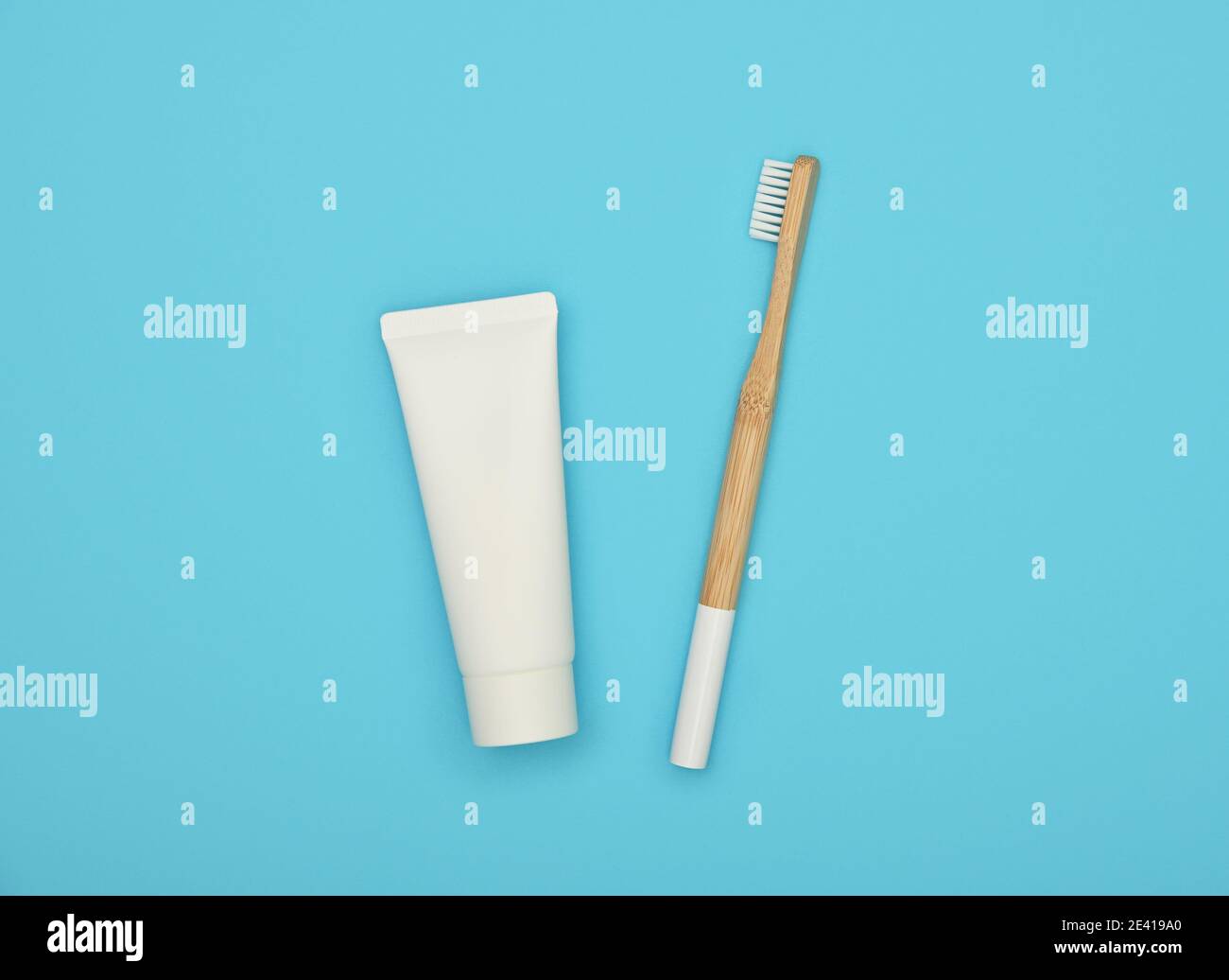Close up one white toothpaste tube and natural wooden bamboo toothbrush ...