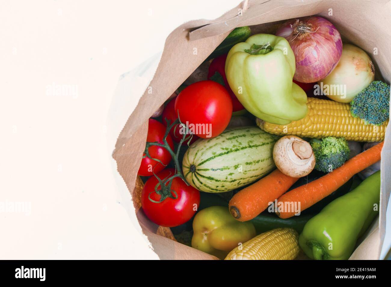 Overhead shot of fresh and organic vegetable mix in a bag isolated on a ...