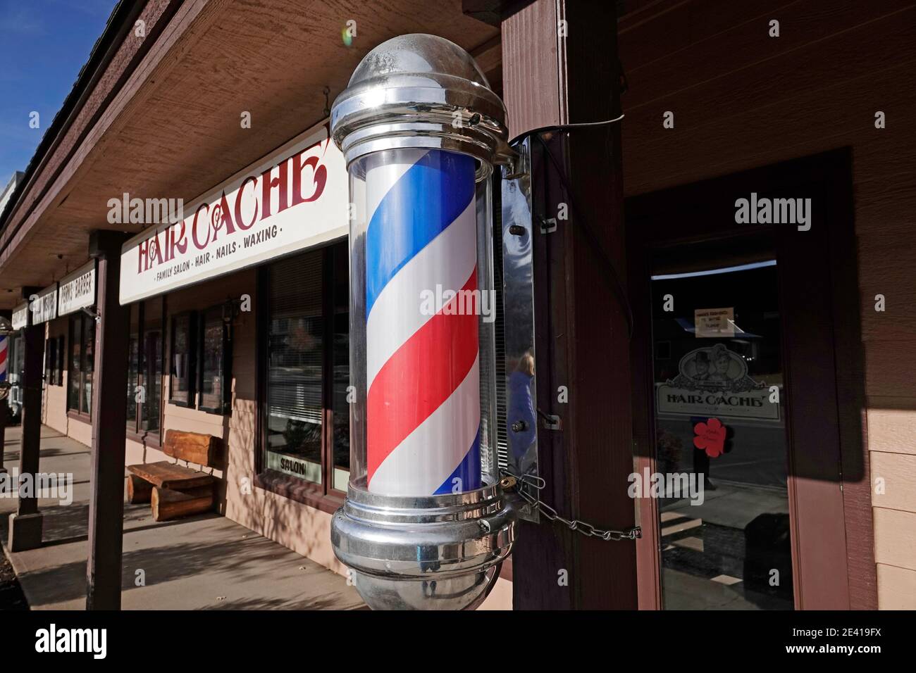 A candy-striped traditional barber pole at a shop in Sisters, Oregon ...