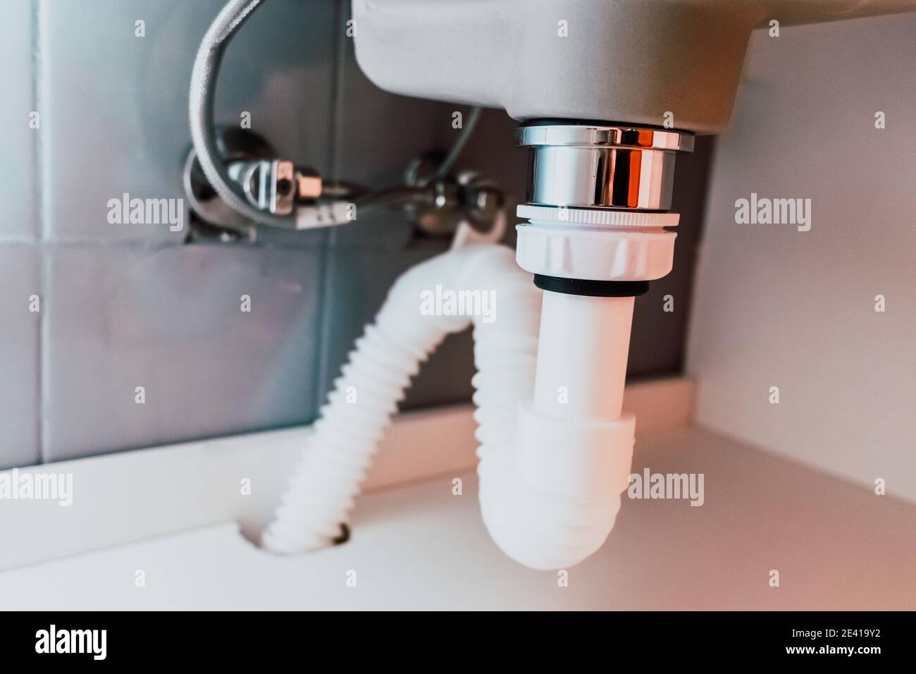 A new basin seen from below with its new white flexible waste pipes ...