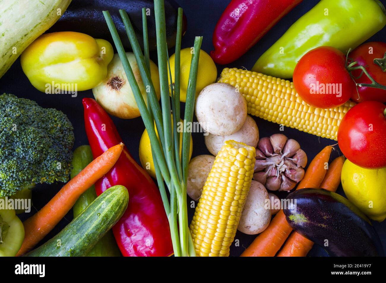Overhead shot of different kinds of fresh vegetables on top of each ...