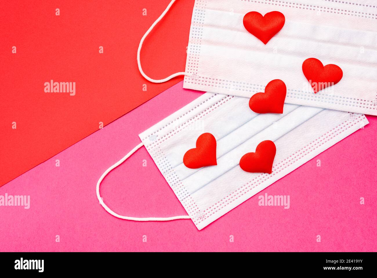 Love in times of pandemic is complicated, masks with hearts on isolated ...