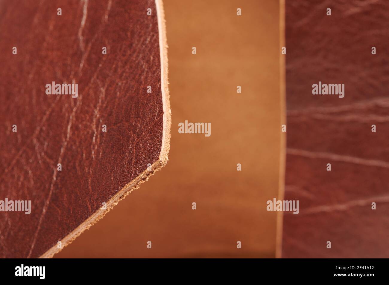 Brown leather sheet selection macro close up view. Corner of raw skin ...