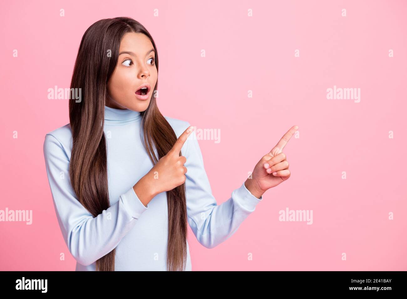 Portrait of little girl indicate fingers empty space unbelievable open ...