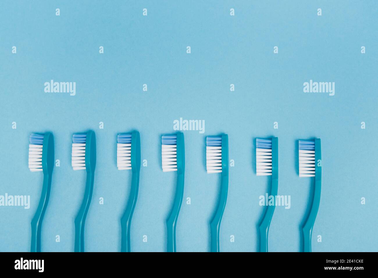 Top view of blue toothbrushes on blue background with copy space Stock ...