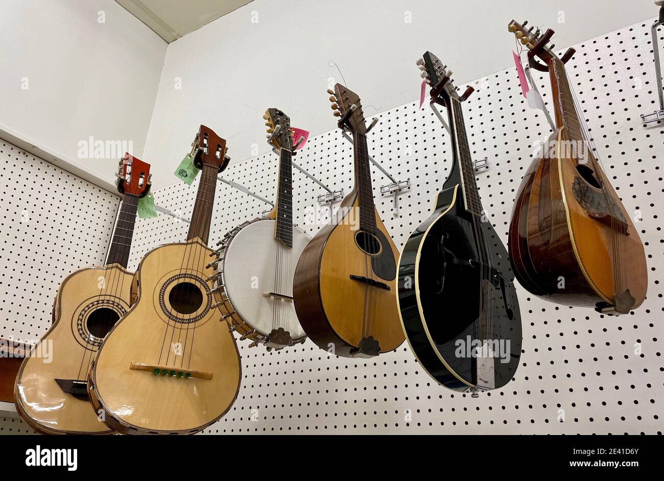 Low angle shot of some different stringed instruments hanging from the ...