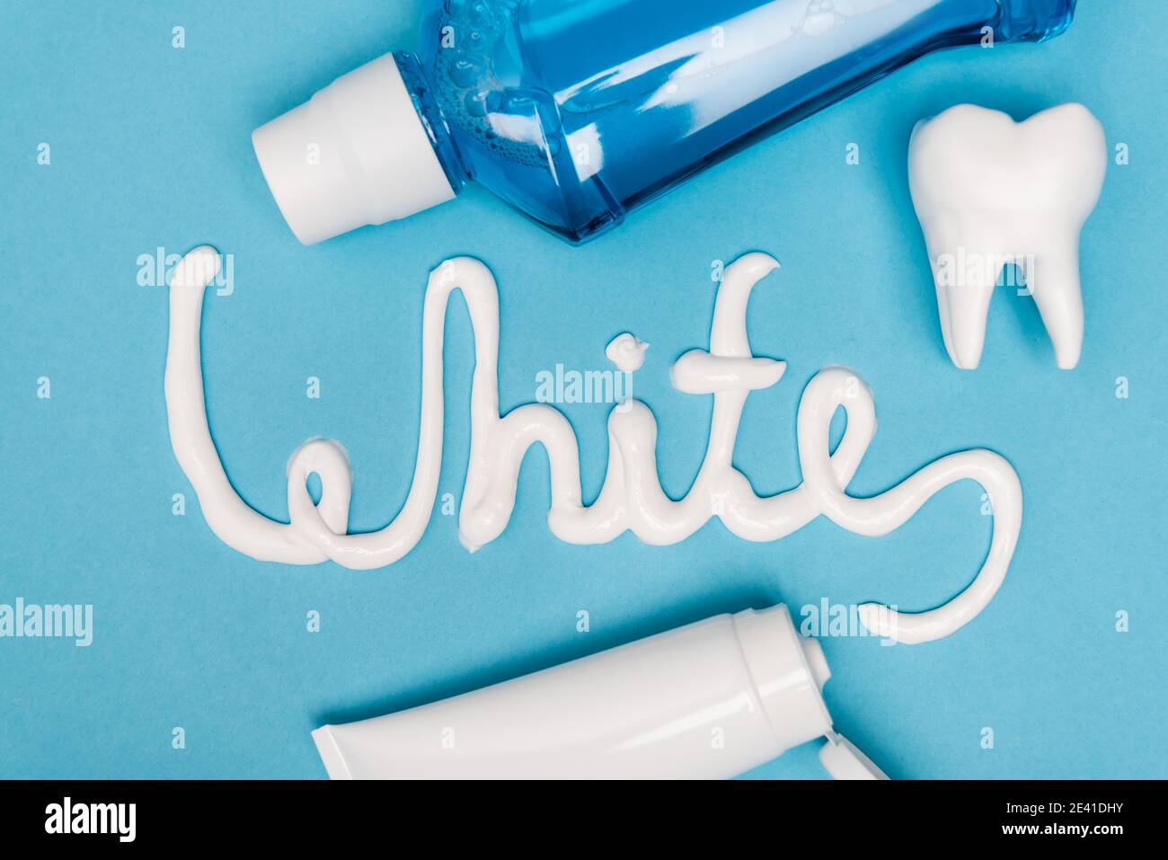 Top view of white lettering from toothpaste, tooth model and mouthwash ...