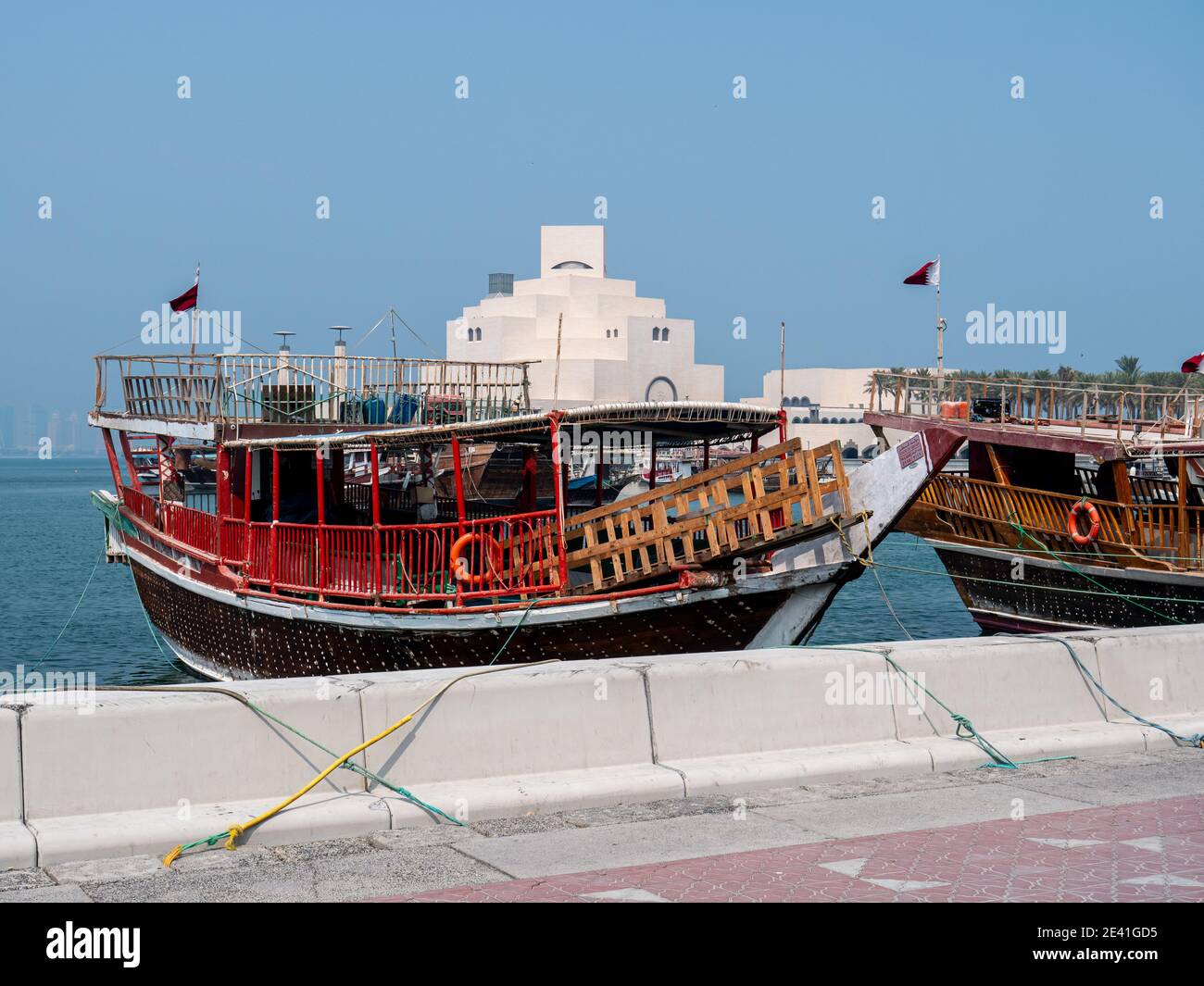 Traditional dhow boats moored in the bay with the Museum of Islamic art ...