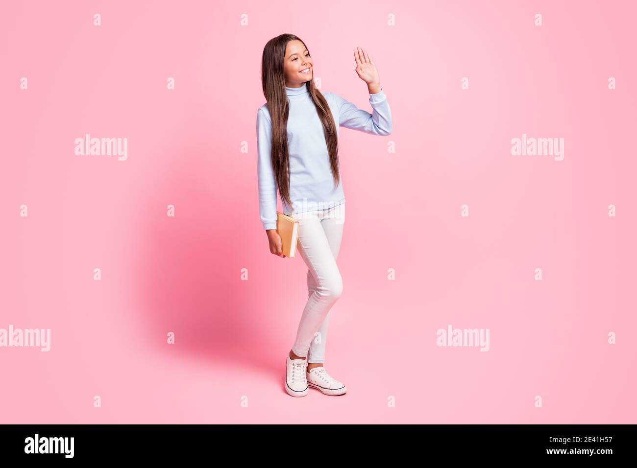 Full length body size view of slender lovely cheerful girl holding book ...