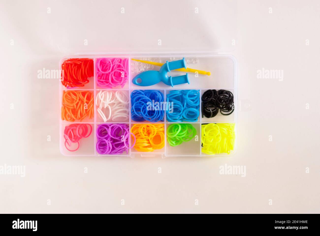 Colorful rubber bands in a box on white background Stock Photo - Alamy
