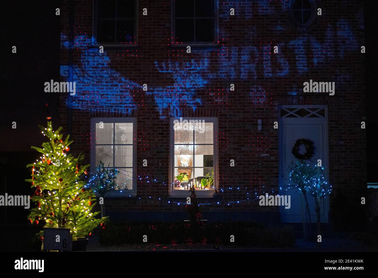 Exterior of a brick house beautifully decorated with Christmas lights ...
