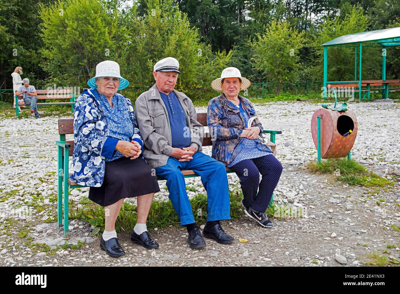 Local elderly Russians resting on bench along Lake Baikal in summer ...