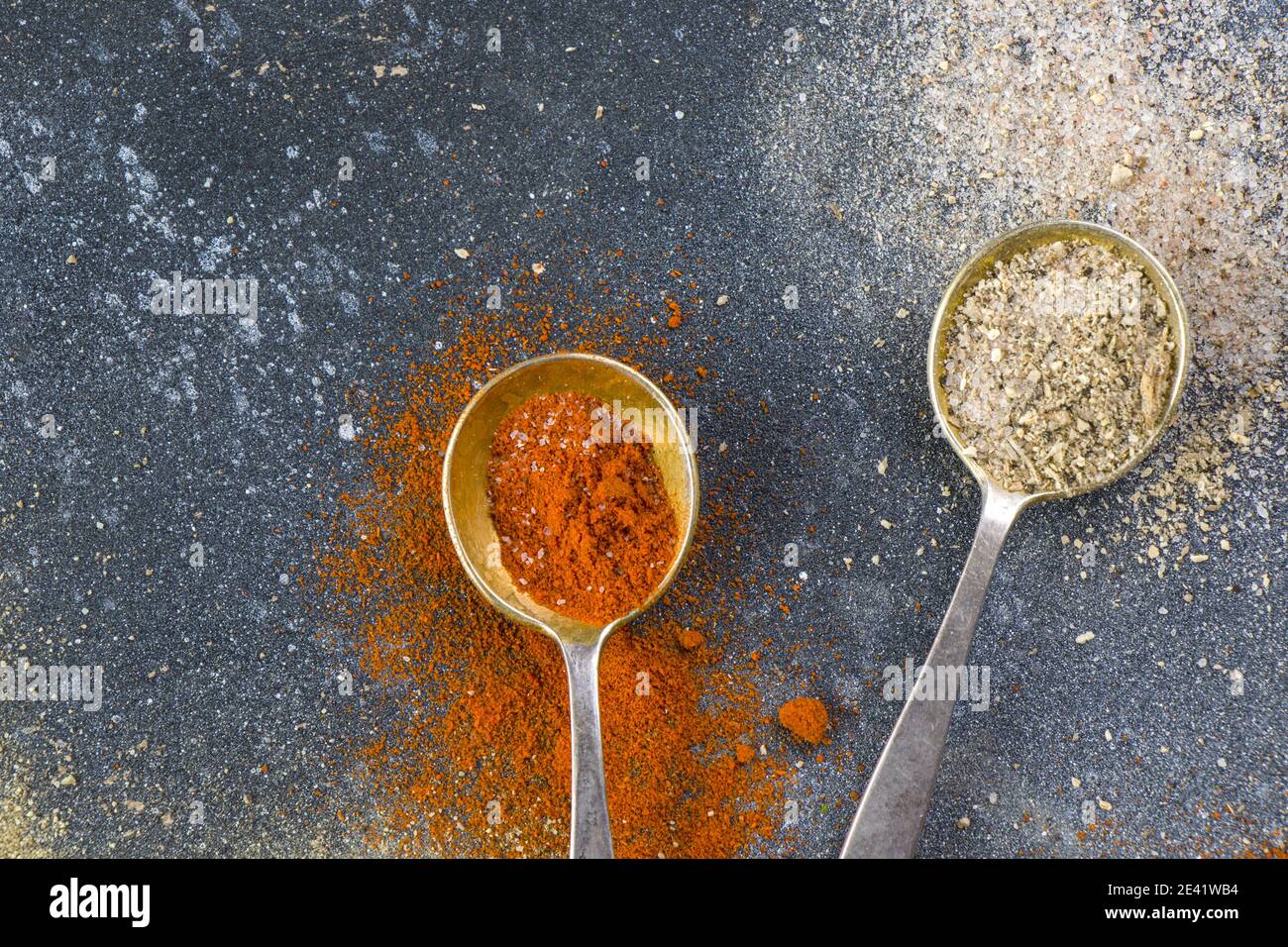 Top view closeup of the variety of spices on the vintage silver spoons ...