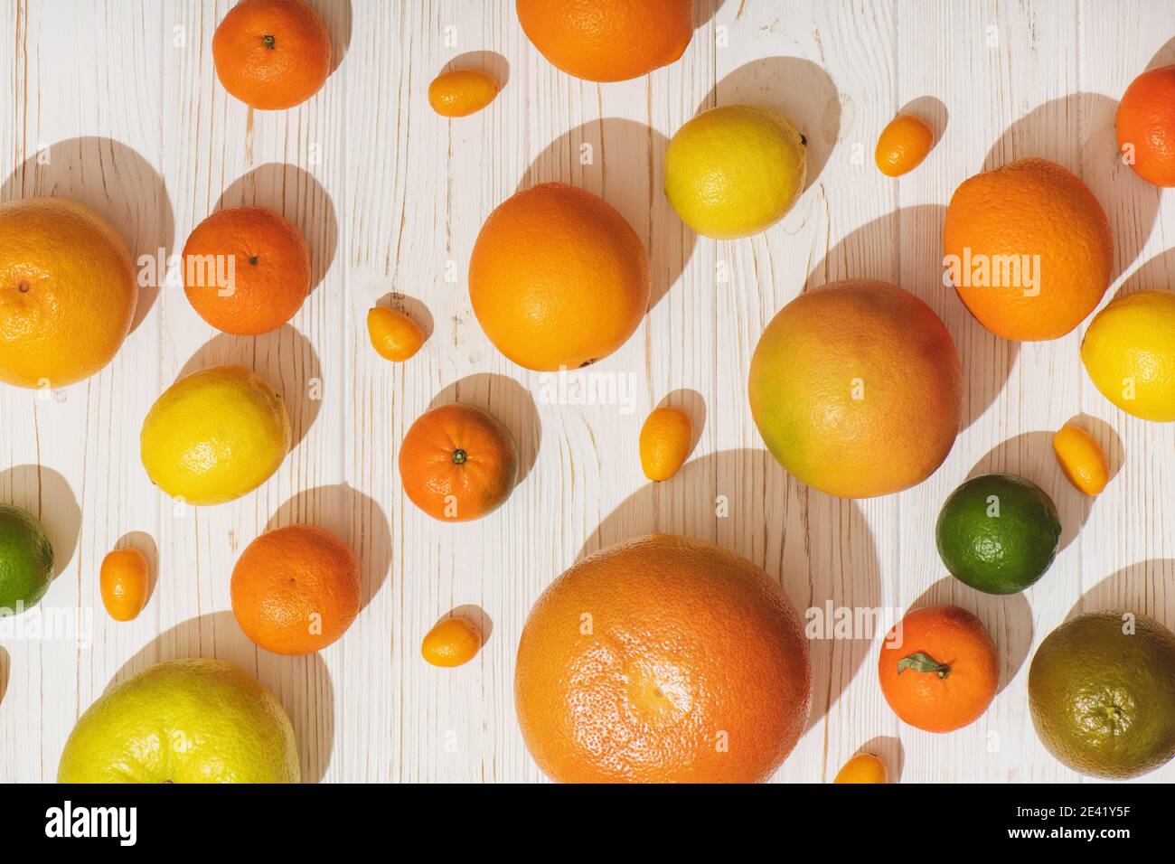 Mix of different citrus fruits on white wooden background Stock Photo ...