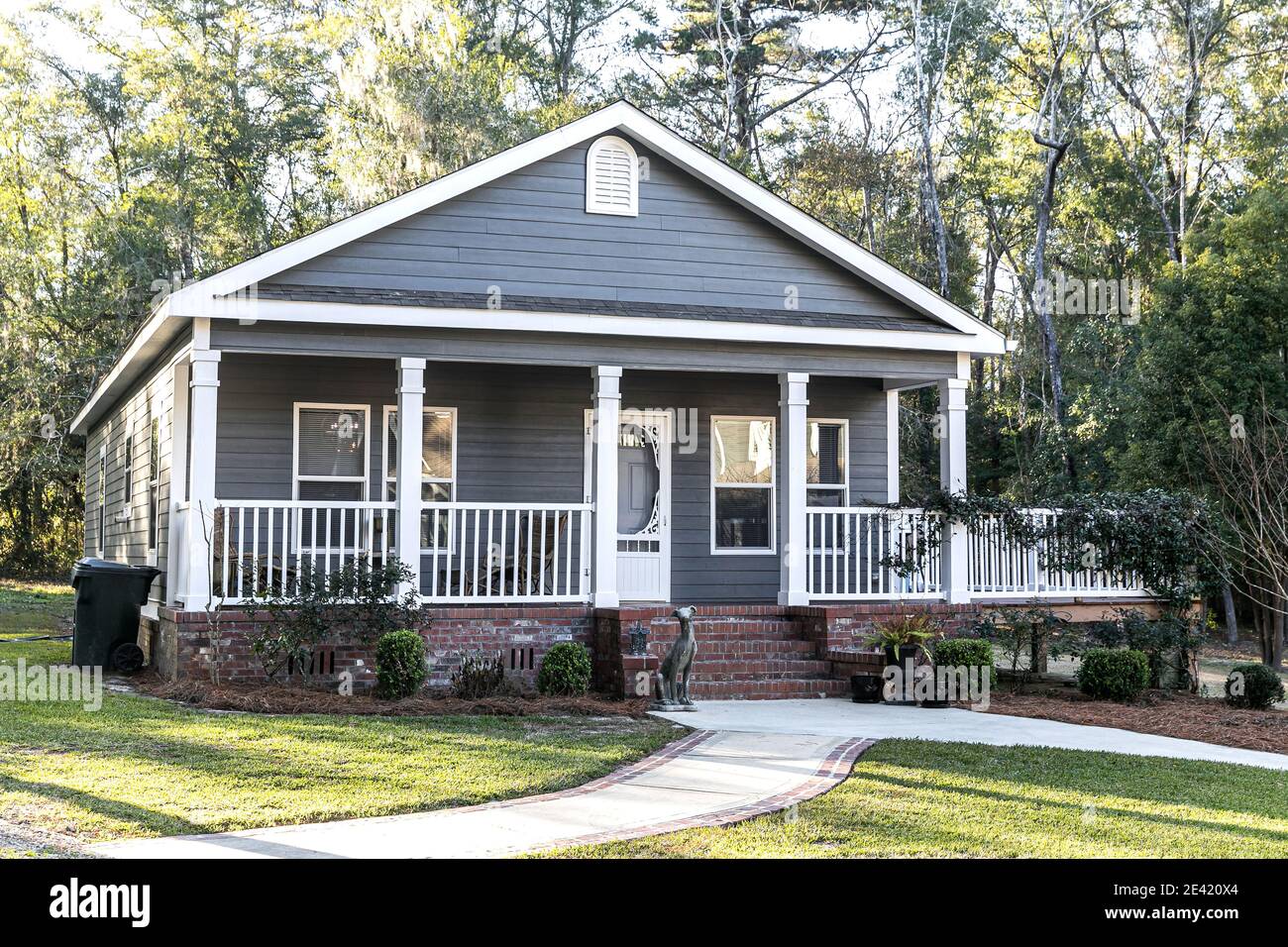 Small blue gray mobile home with a front and side porch with white ...