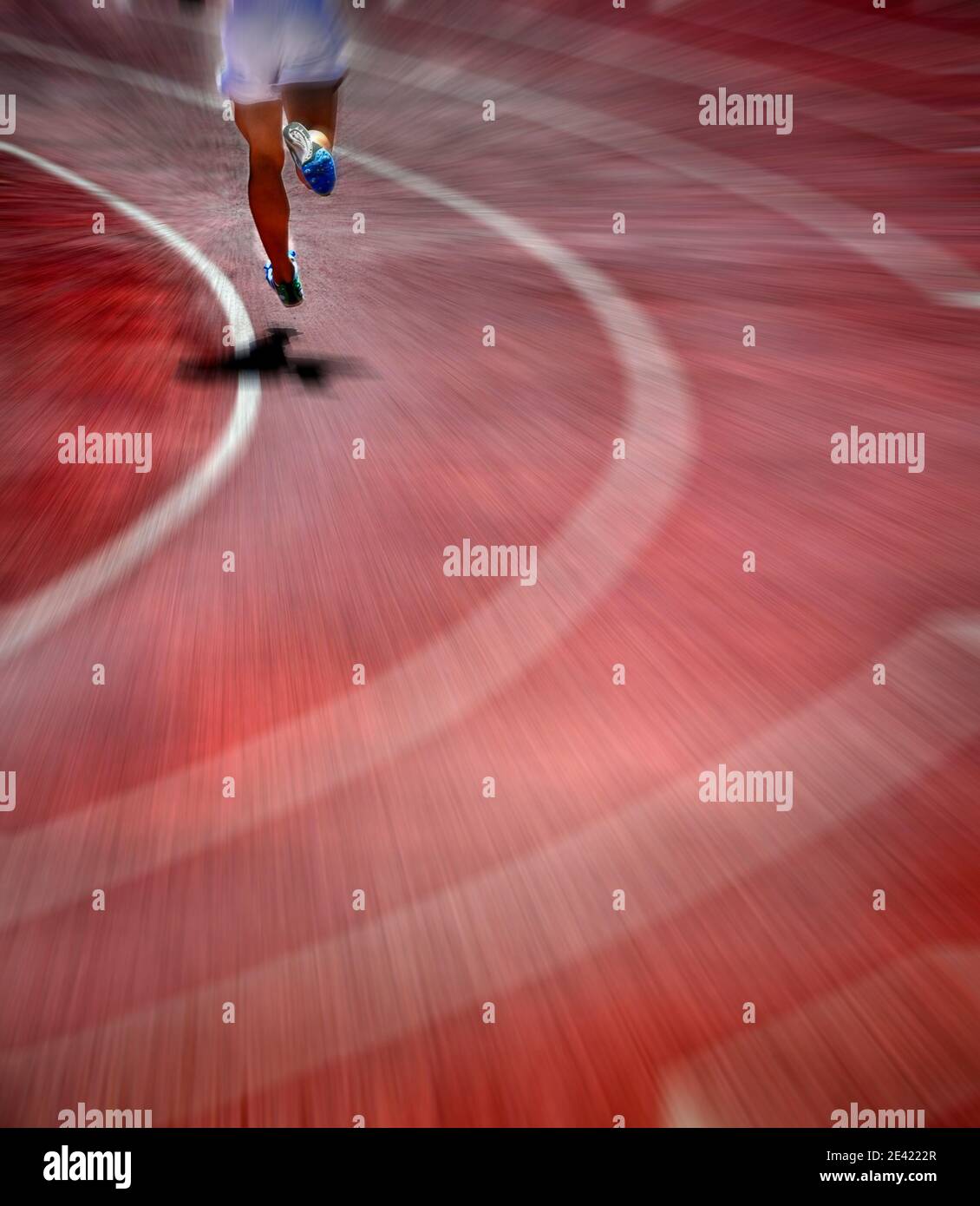 Runner on lanes of a red race track with a curve at the end fast speed ...