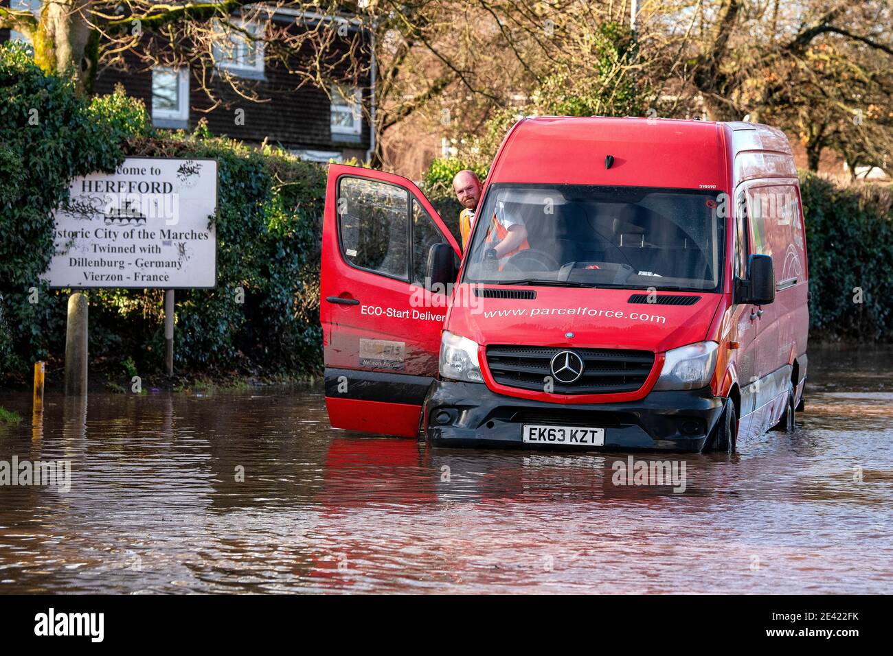 A Parcelforce delivery van is stranded in flood water in Hereford as ...