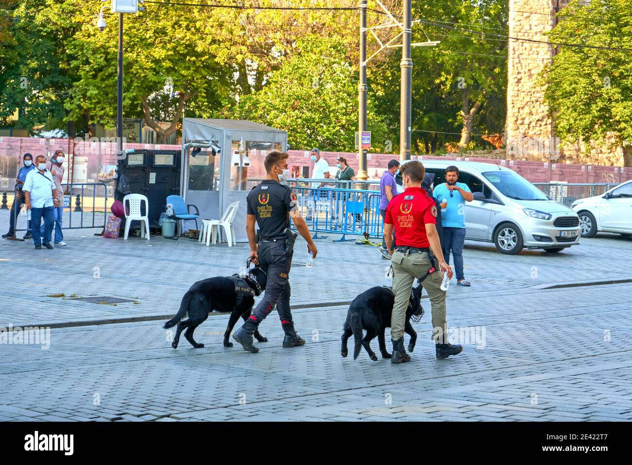 Two police officers with dogs patrolling popular tourist spot ...