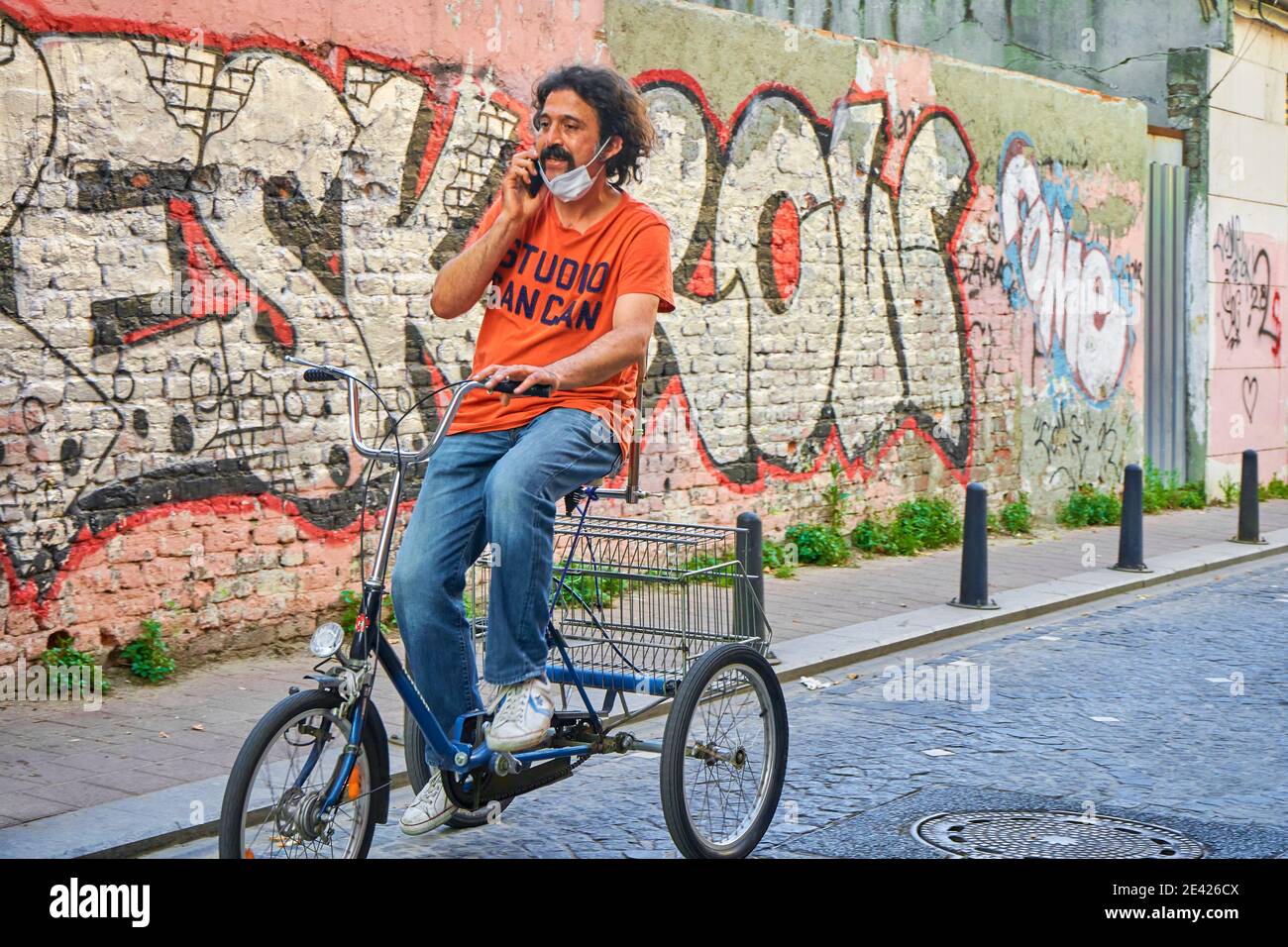 Man ride on tricycle in jewish district of Istanbul Stock Photo - Alamy