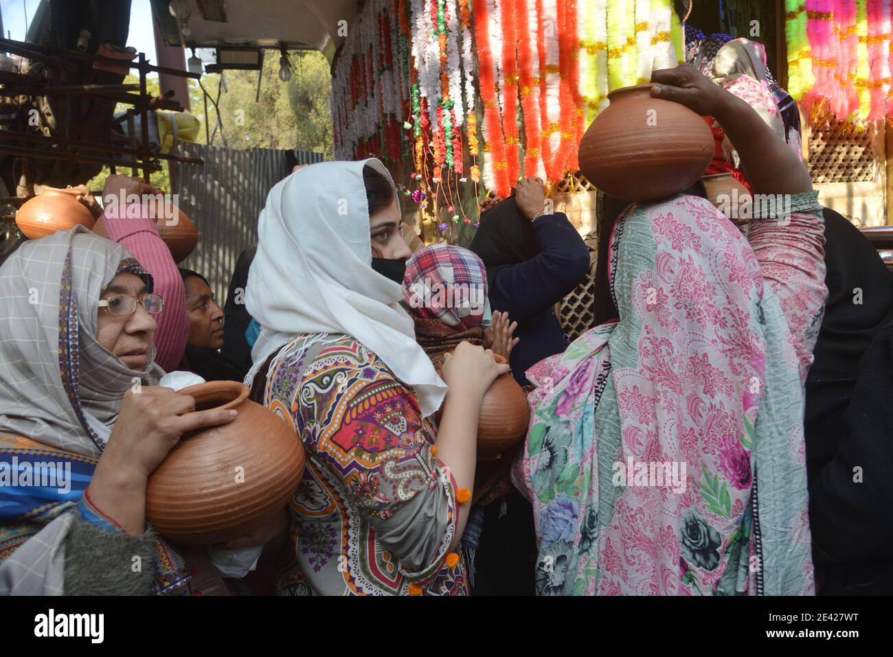 Pakistani women devotees bringing water for ablution of the graves at ...