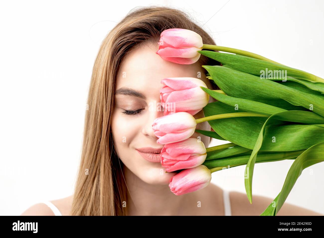 A portrait of a happy young caucasian woman with closed eyes and pink ...