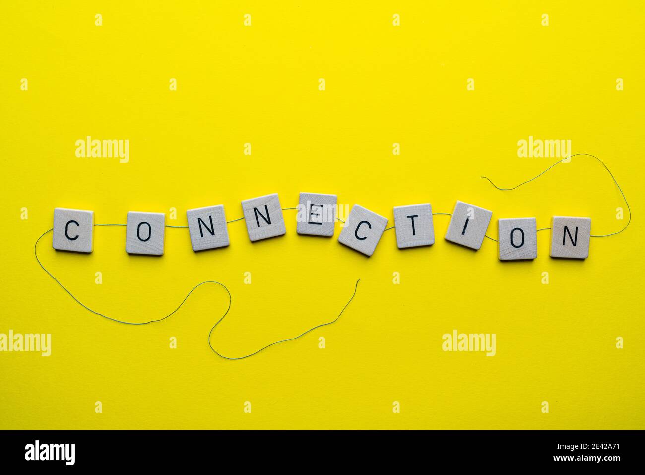 the word connection formed with the letters linked together by a thread ...
