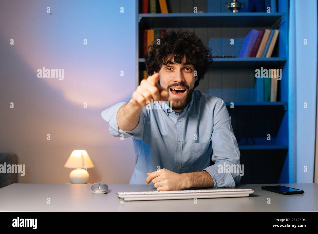 Front view of cheerful young businessman talking on video call and ...