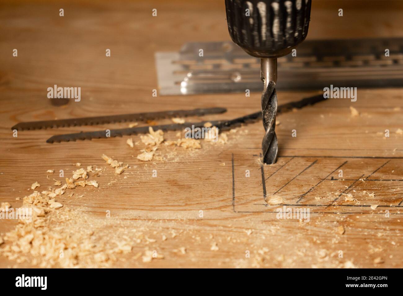 Wood processing. Drilling a hole in a wooden board using pencil ...