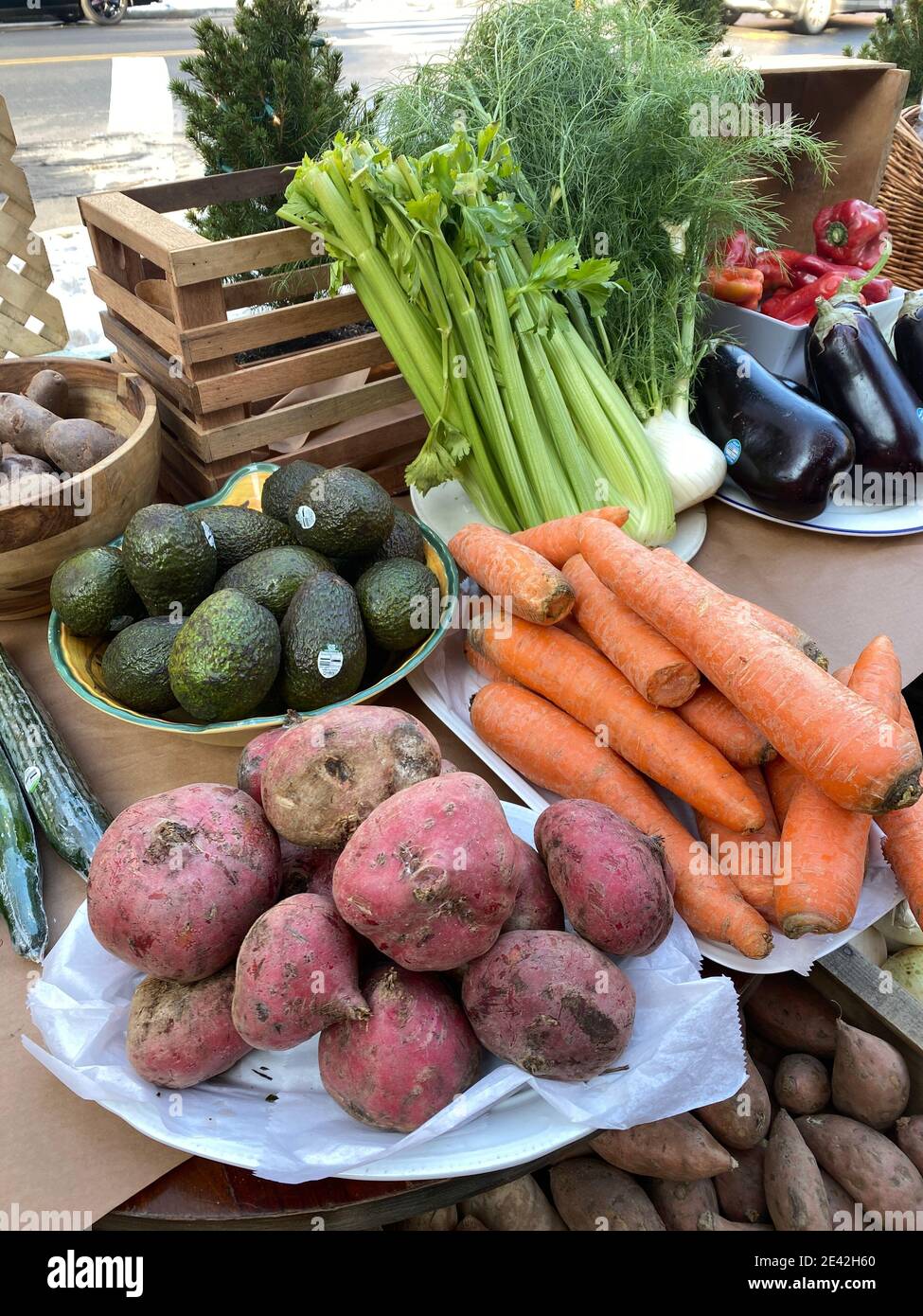Fresh vegetables for sale on the street in front of a closed restaurant ...