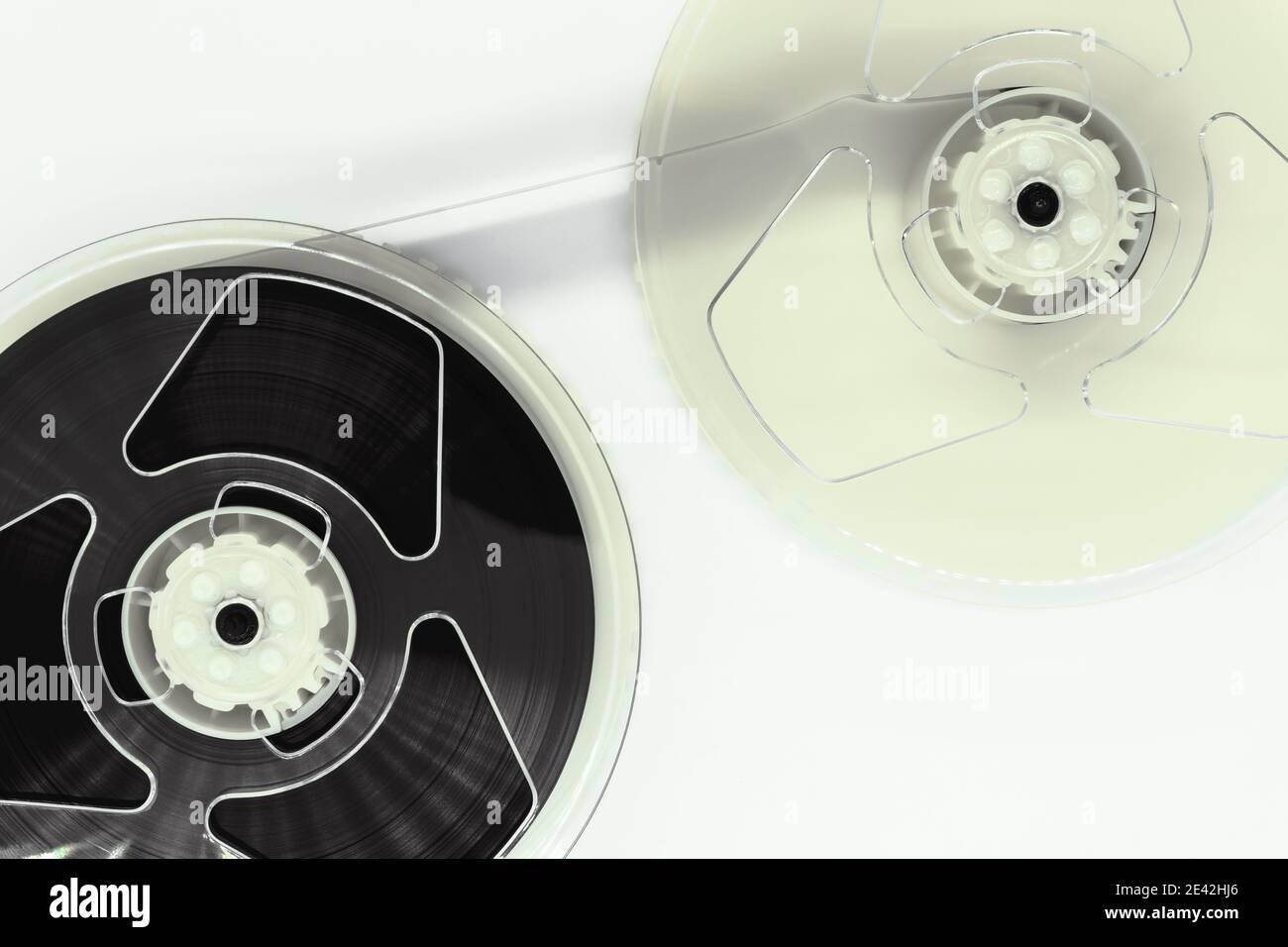 Abstract composition of video home system VHS tape reels on white ...