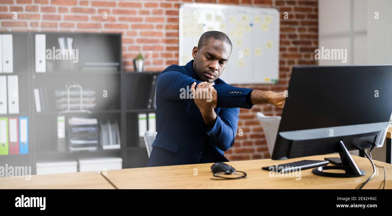 African American Man Doing Stretch Exercise In Office At Work Stock ...