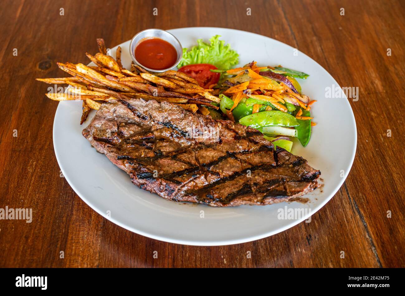 Steak Dinner with vegetables on white plate and wood table Stock Photo ...