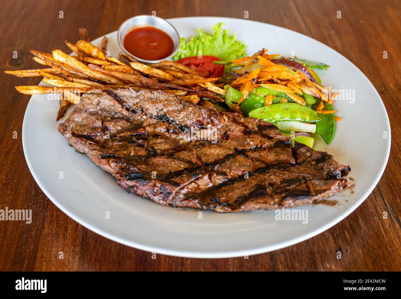 Steak Dinner with vegetables on white plate and wood table Stock Photo ...