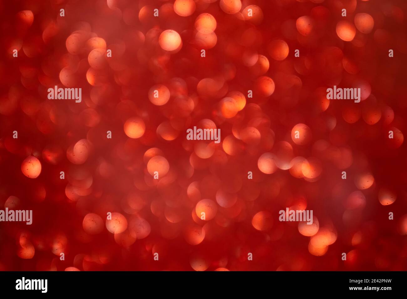 Red bokeh blurred background. Red festive background with glitter for ...