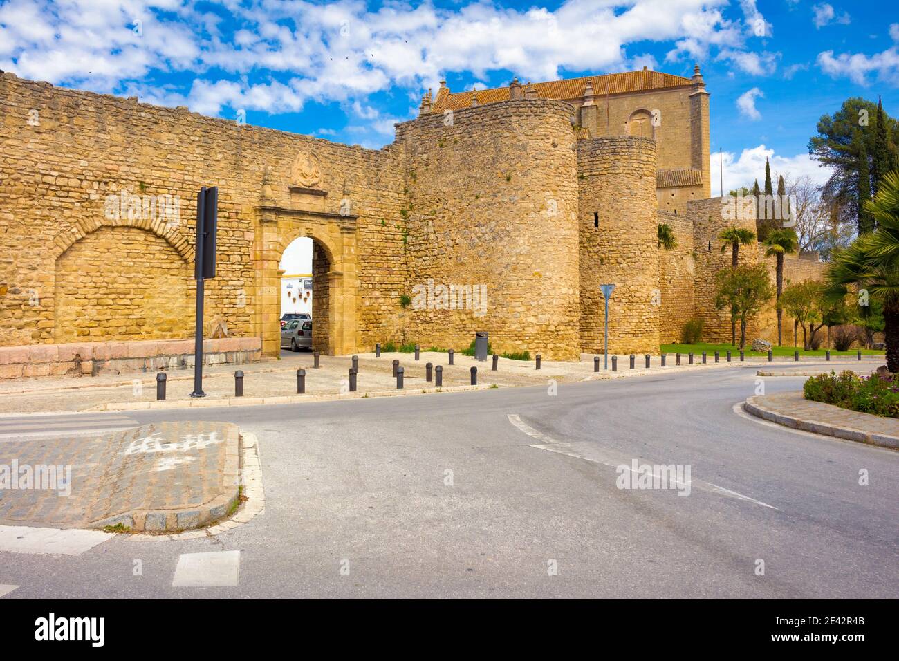 View of the Arab walls with the door of Almocabar, in Ronda, Andalucia ...