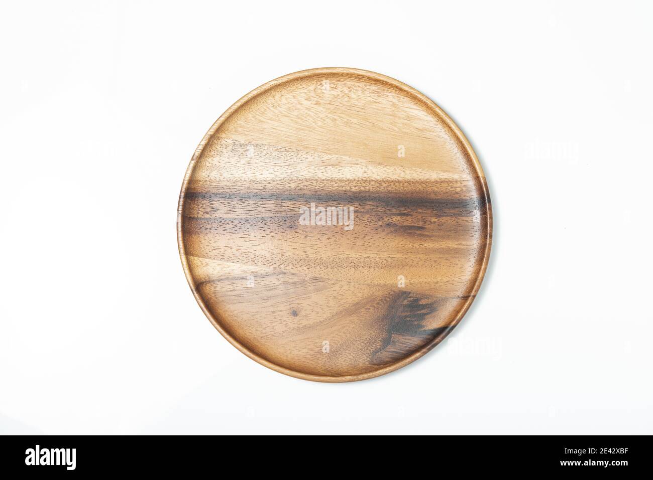 Top view of a simple handmade wooden plate isolated on a white ...