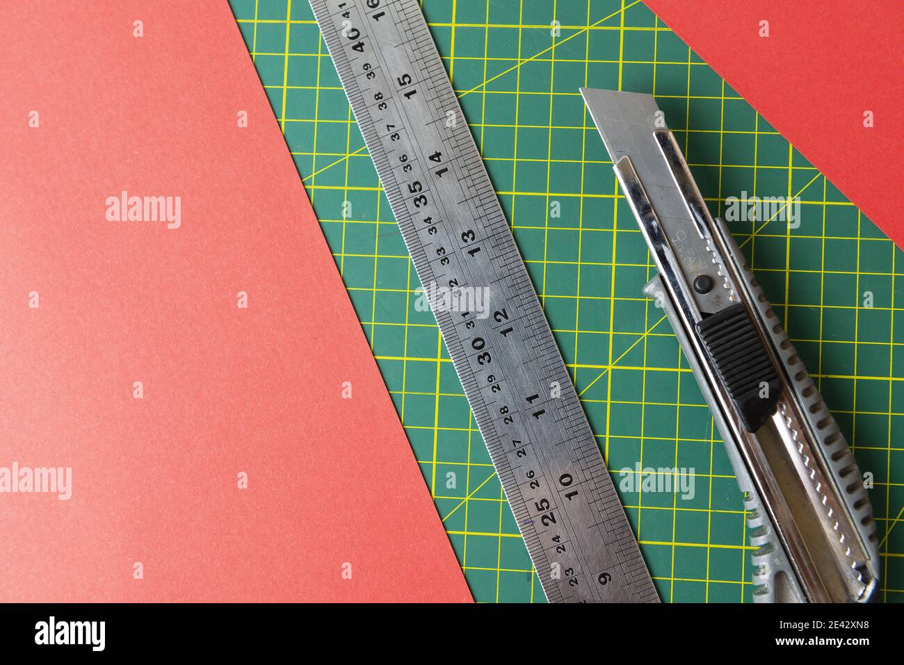 Top view of a cutter and a ruler on a cutting mat under the light Stock ...