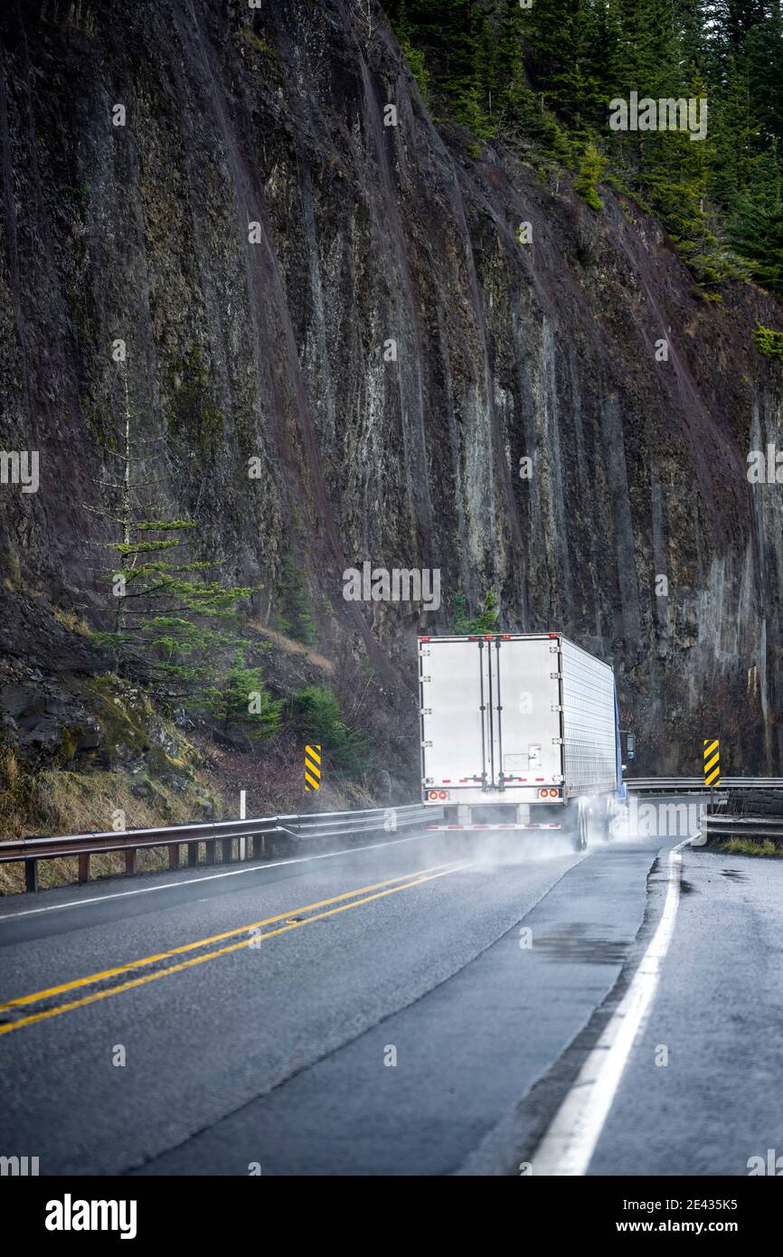 Big rig powerful blue semi truck with pipes grill guard transporting ...