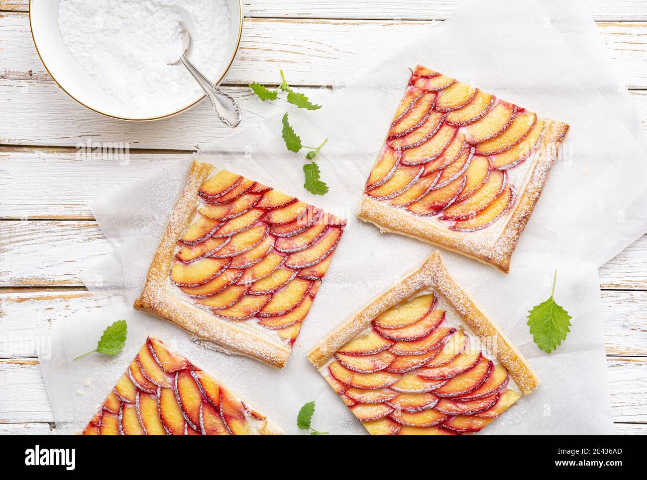 Refreshing delicious dessert, juicy nectarine puff pastry tarts with ...
