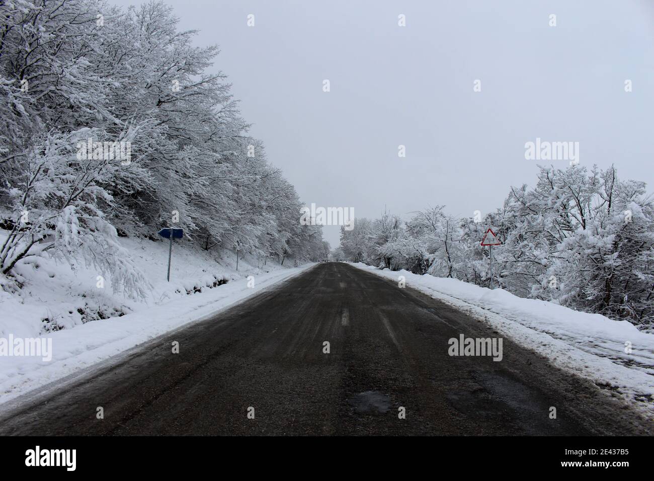 Snowy road in winter season. Road through snowy forest. Gabala ...