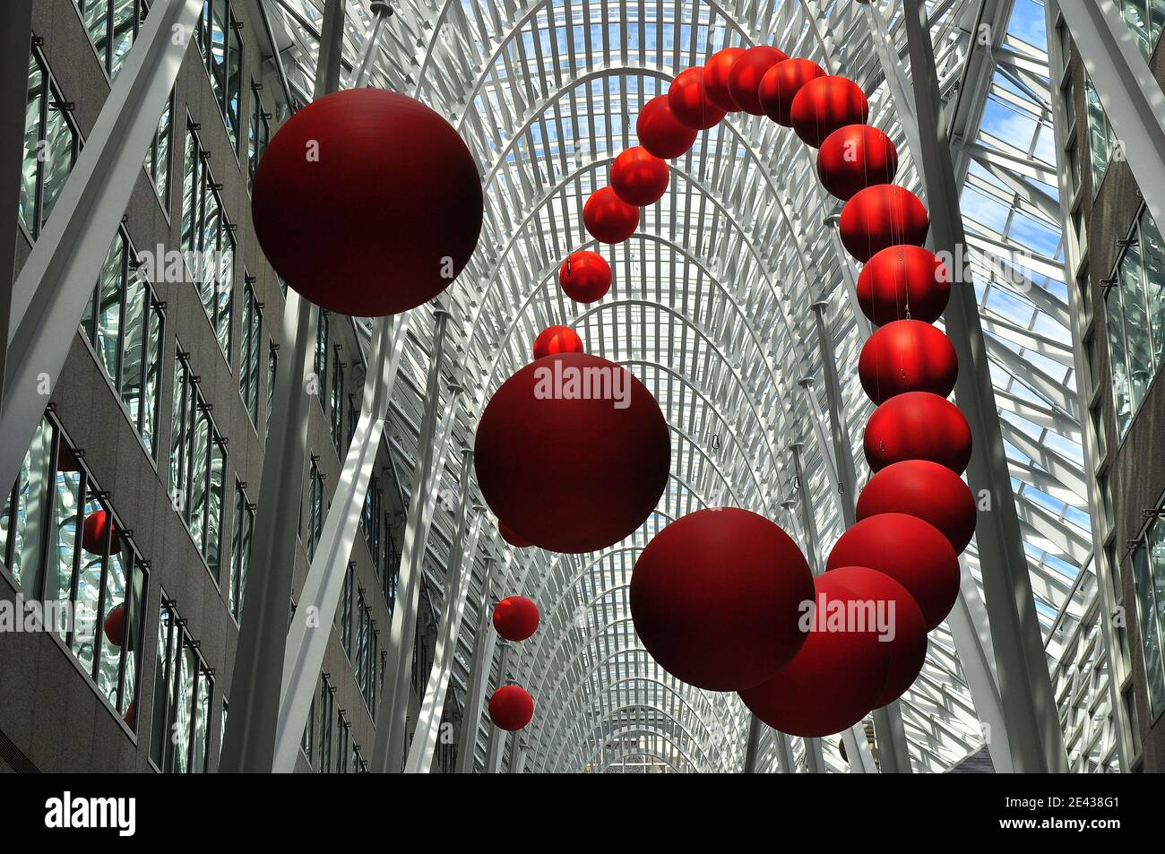 A group of red balls is installed as street artwork on the atrium of an ...