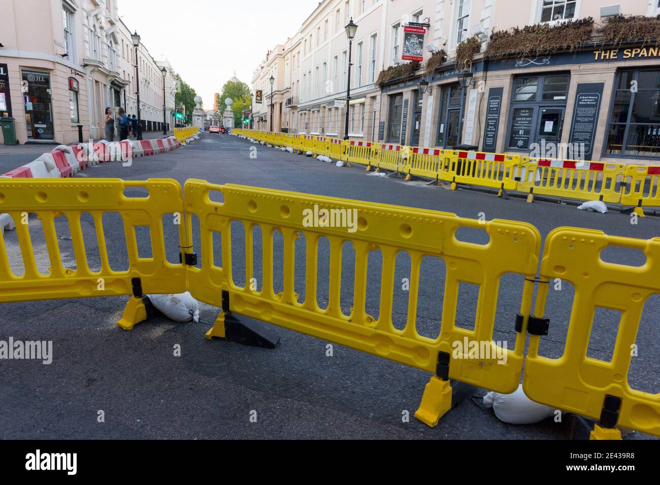 road barriers close off part of road as widen pavement for people to ...