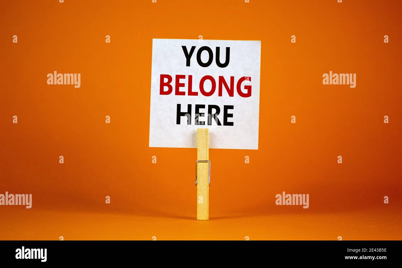 You belong here symbol. Wooden clothespin with white paper. Words 'you ...