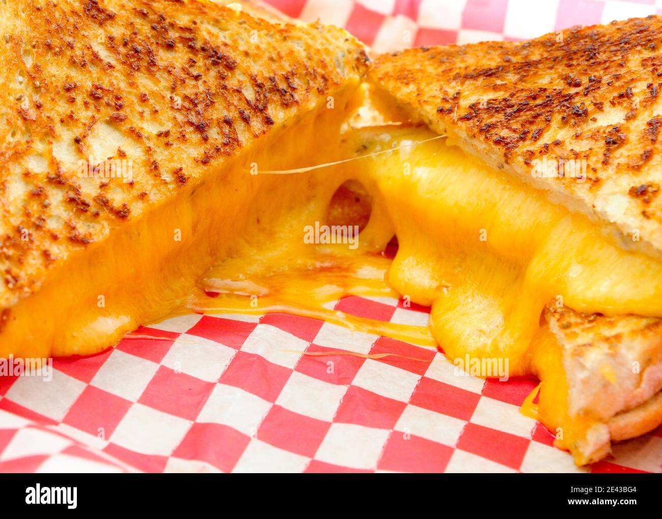 decadent grilled cheese sandwiches with oozing cheese running ou Stock ...