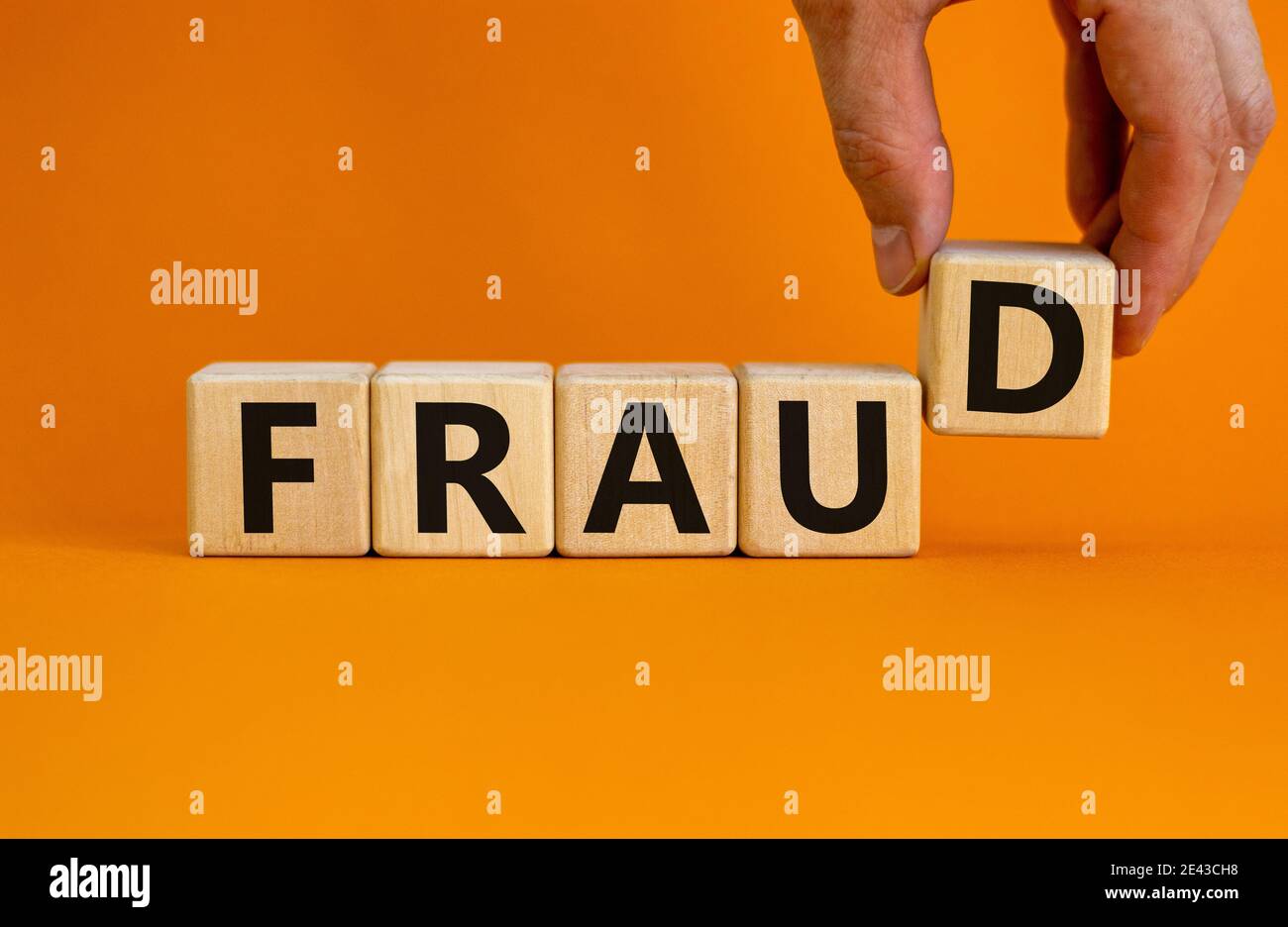 Fraud symbol. Concept word fraud on wooden cubes on a beautiful orange ...