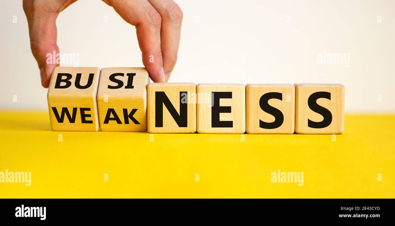 Business or weakness symbol. Businessman hand turns wooden cubes and ...